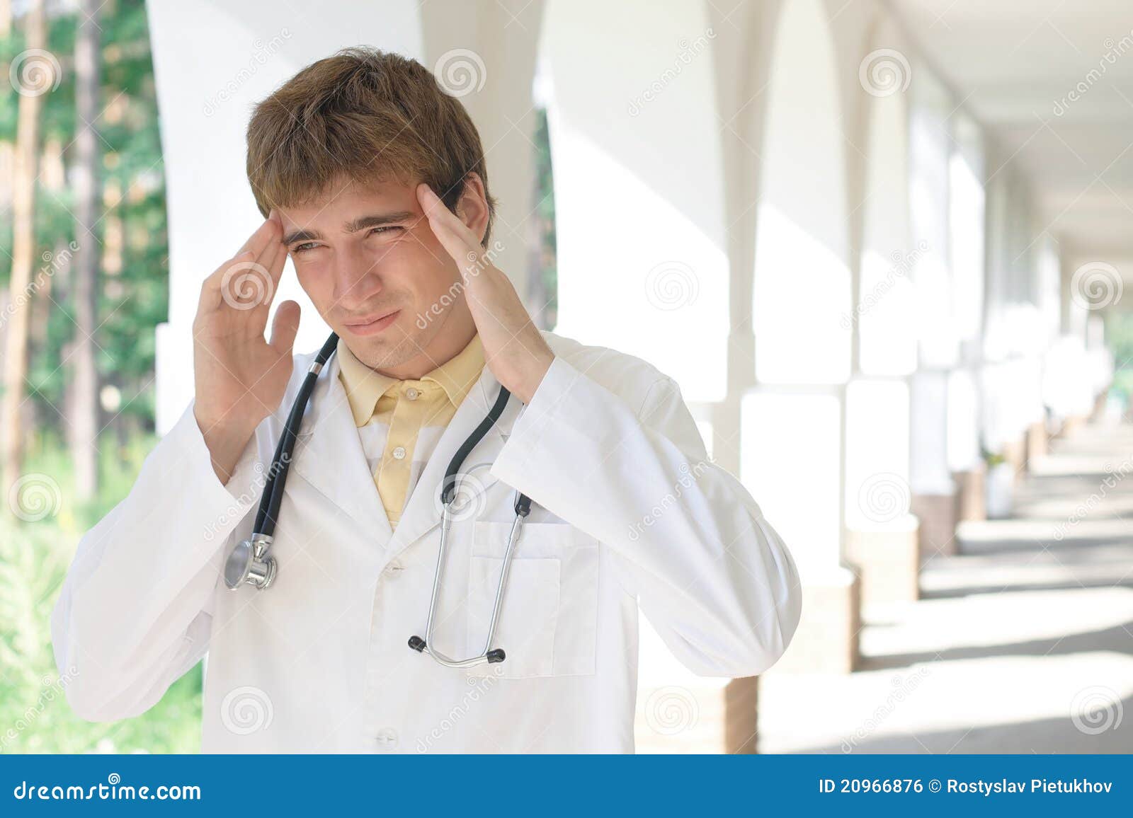 Young Doctor with a Headache Stock Photo - Image of clinic, coat: 20966876