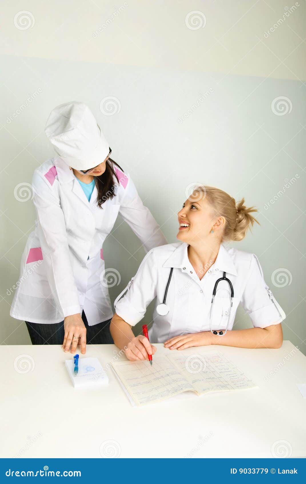 Young Doctor With Her Assistant In The Office Stock Image - Image of ...