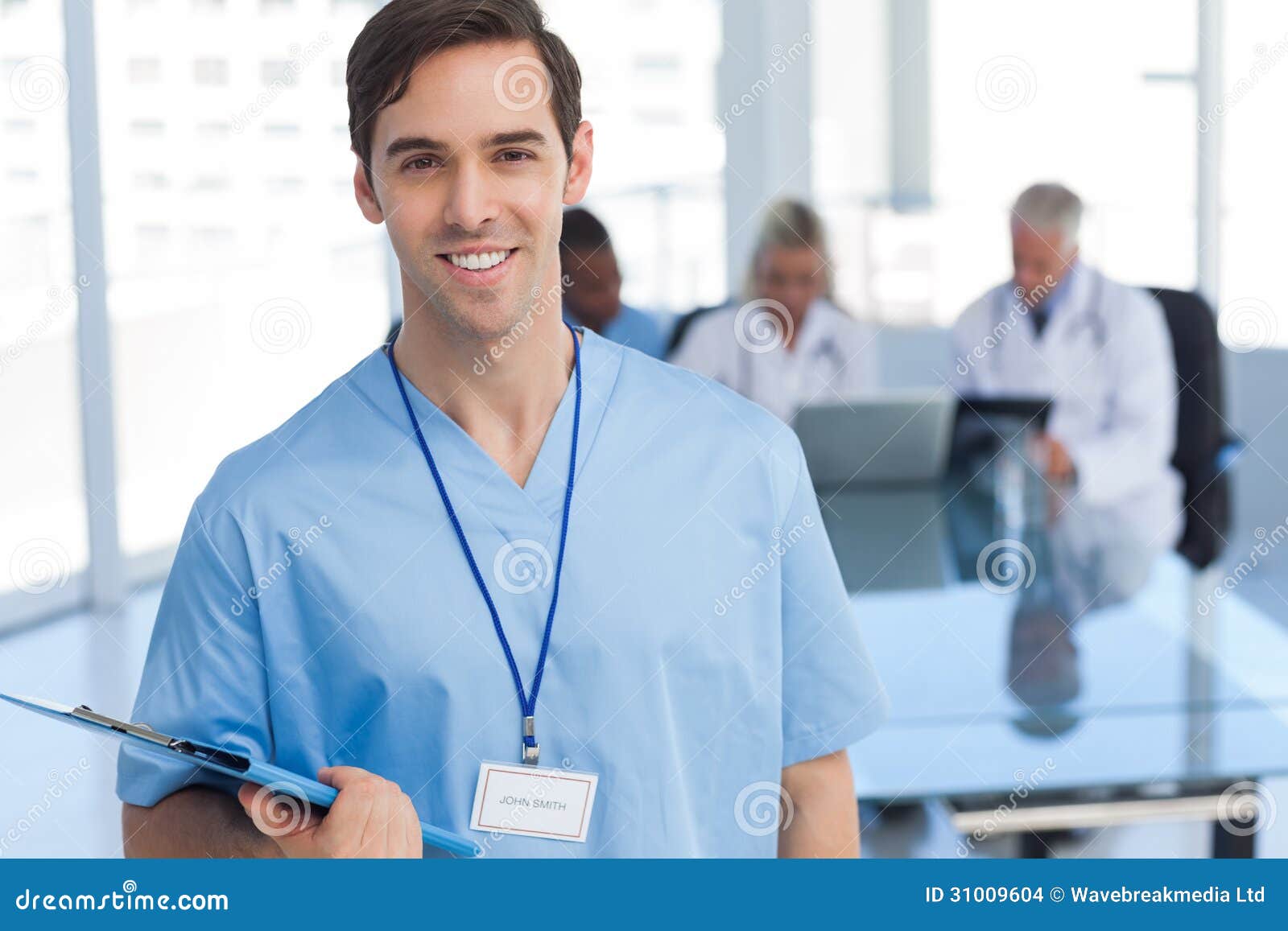 Young Doctor Holding a File Stock Photo - Image of handsome, camera ...