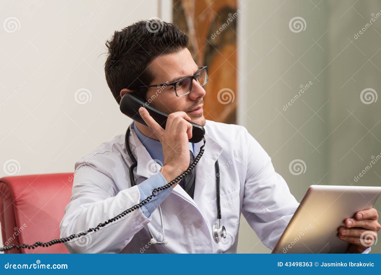 Young Doctor on the Phone stock image. Image of computer - 43498363