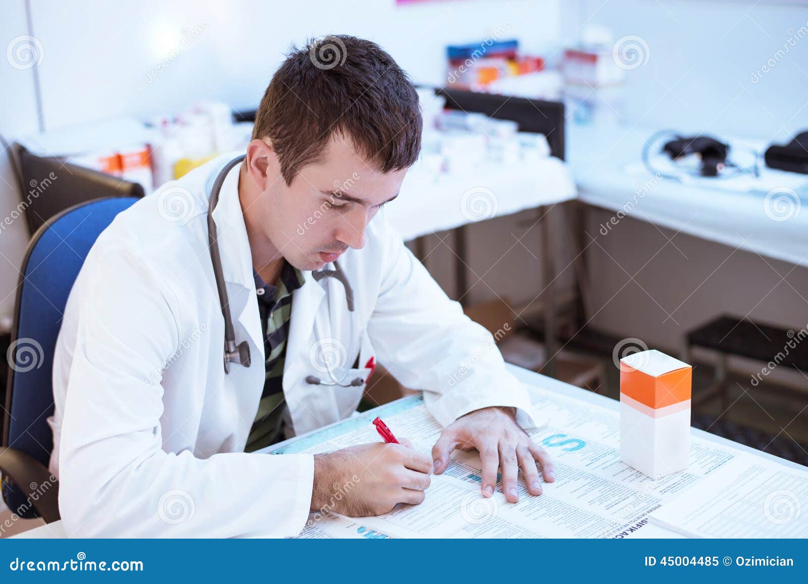 Young Doctor Prescribing Recipe Stock Image - Image of clinic, male ...
