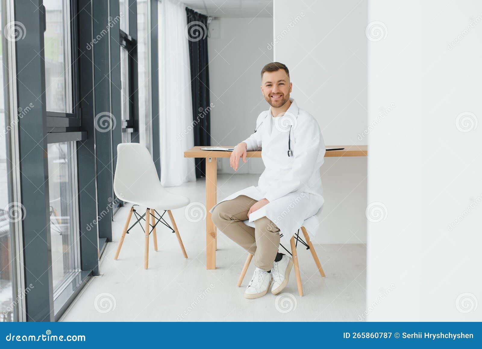 Young Doctor Sitting in His Office Behind a Desk. Stock Image - Image ...