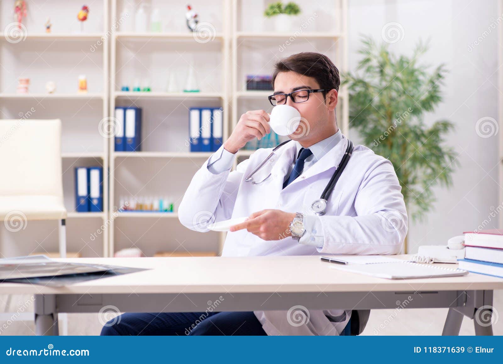 The Young Doctor Sitting in the Office Stock Image - Image of ...
