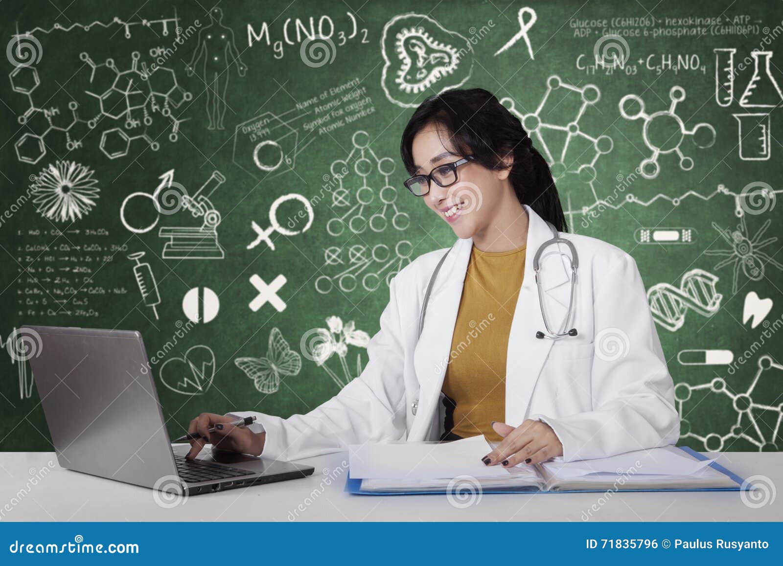 Young Doctor Typing on Notebook Stock Photo - Image of office, hispanic ...