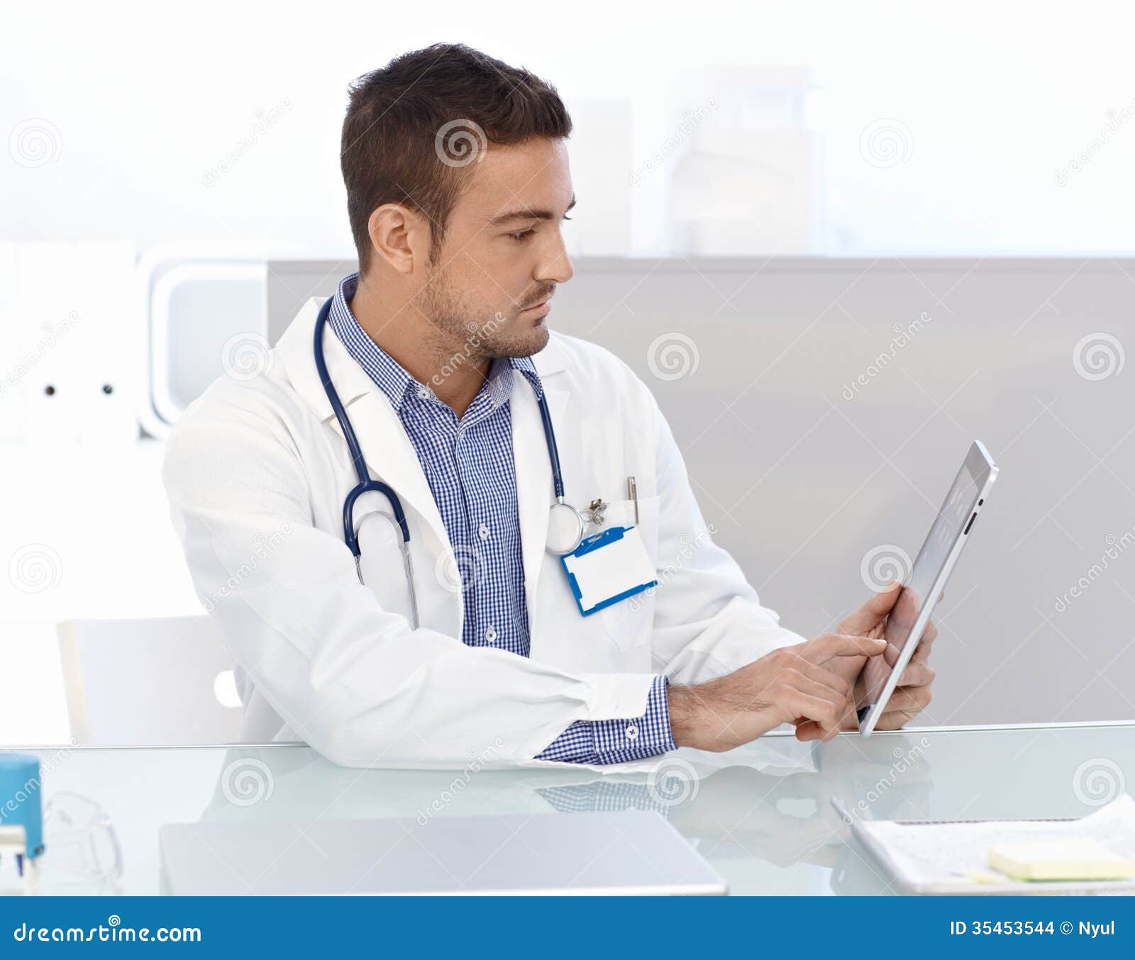 Young Doctor Using Tablet Computer Stock Photo - Image of copyspace ...