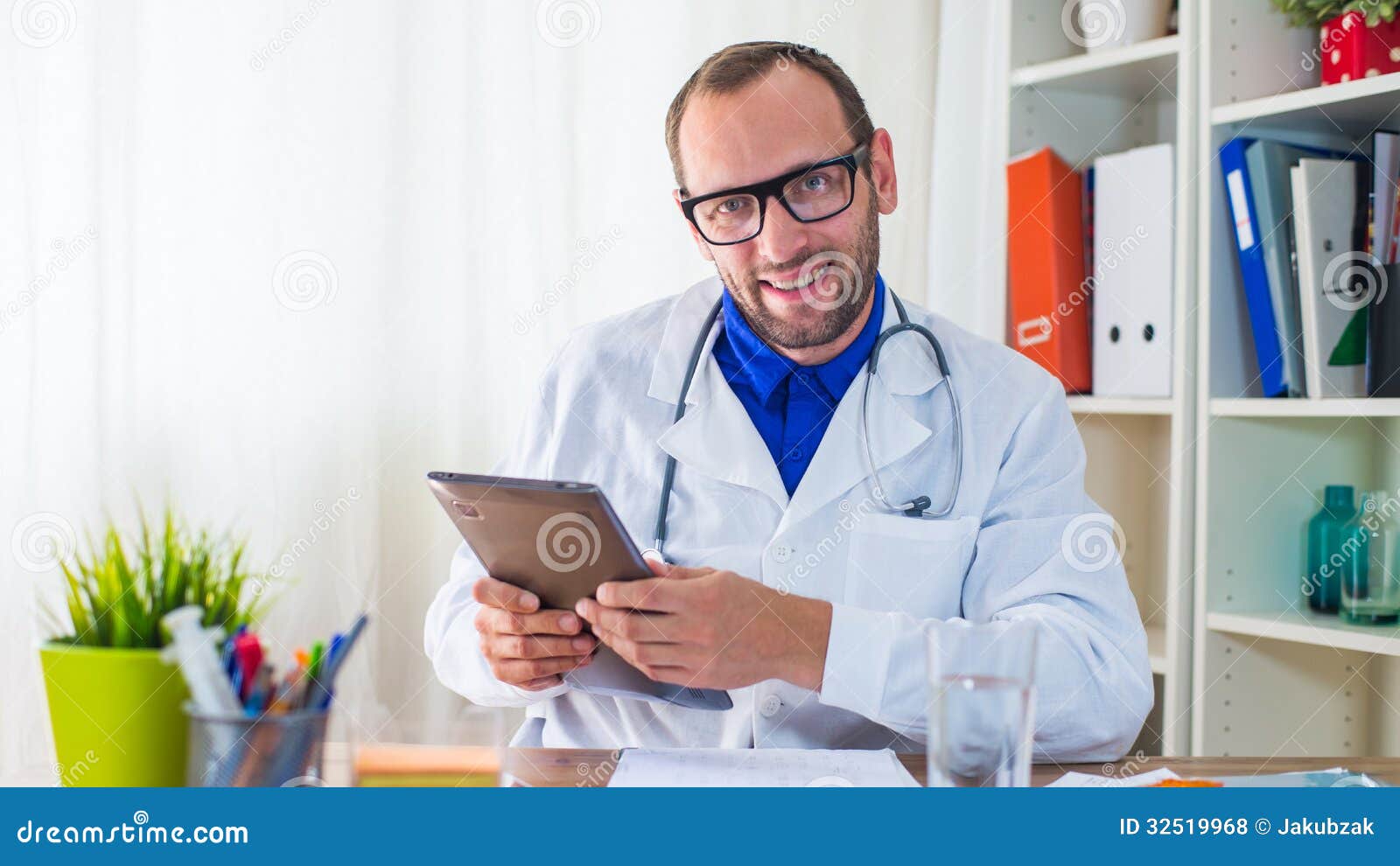 Young Doctor Using Tablet in His Surgery. Stock Photo - Image of ...