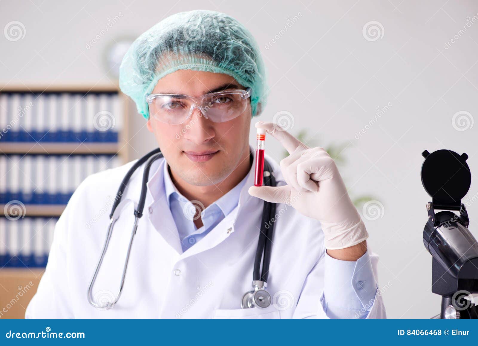 The Young Doctor Working in the Lab with Microscope Stock Photo - Image ...