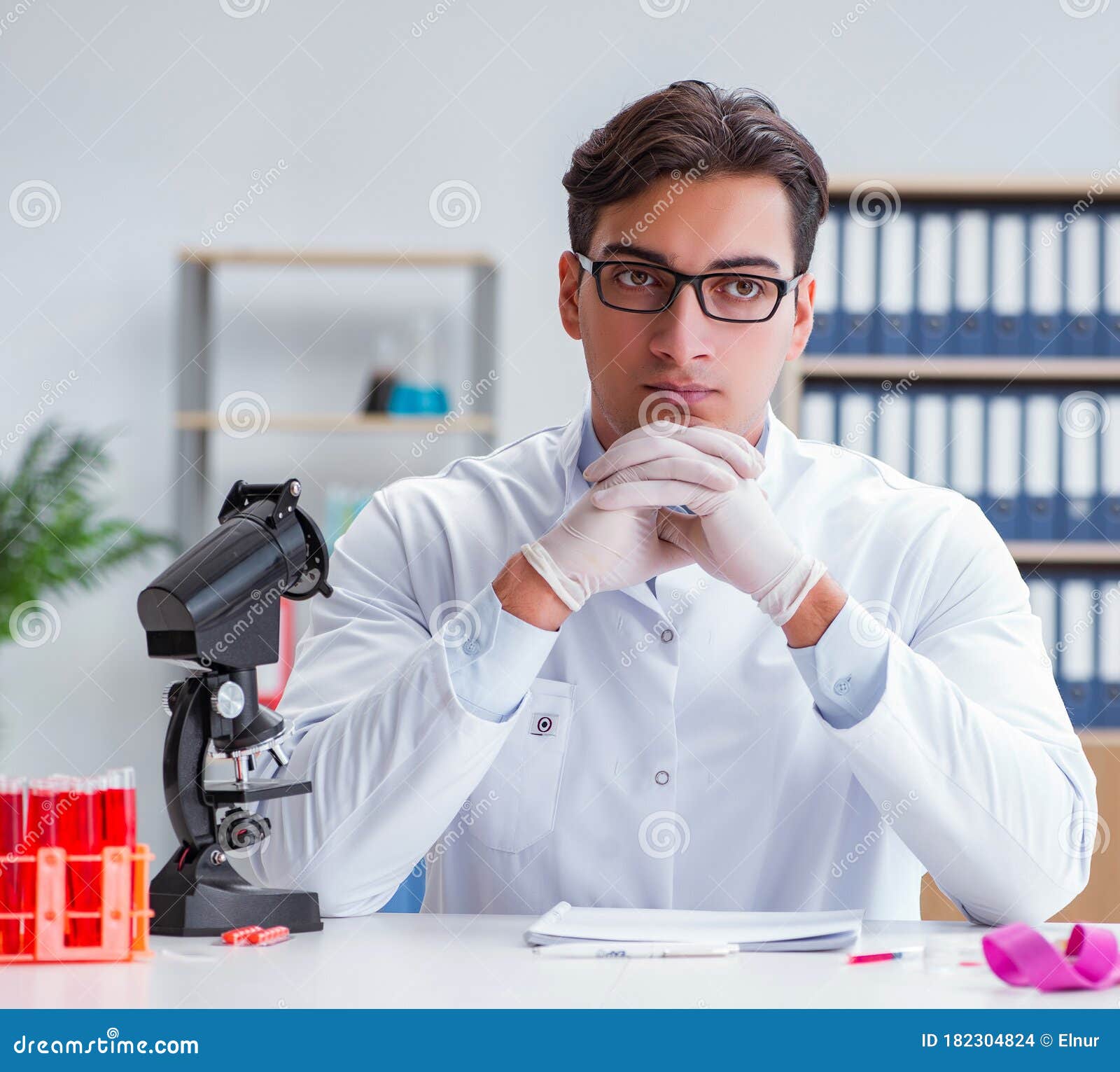 Young Doctor Working in the Lab with Microscope Stock Photo - Image of ...