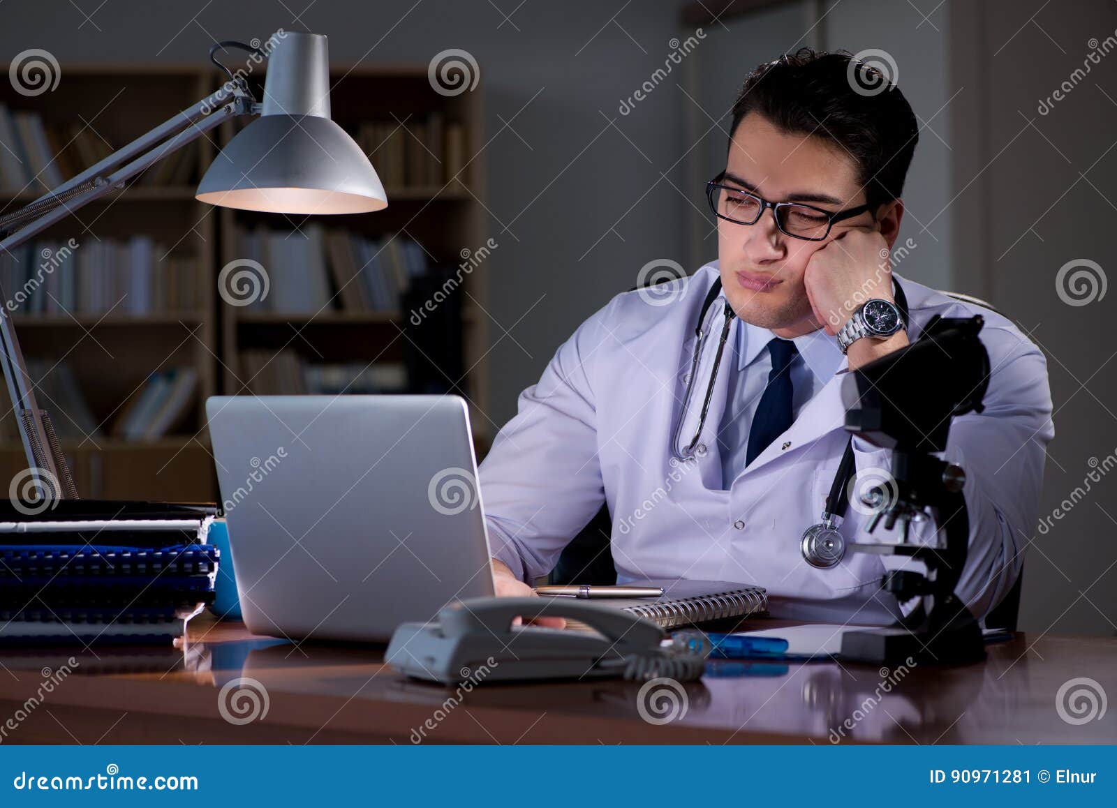 The Young Doctor Working Late in the Office Stock Image - Image of ...