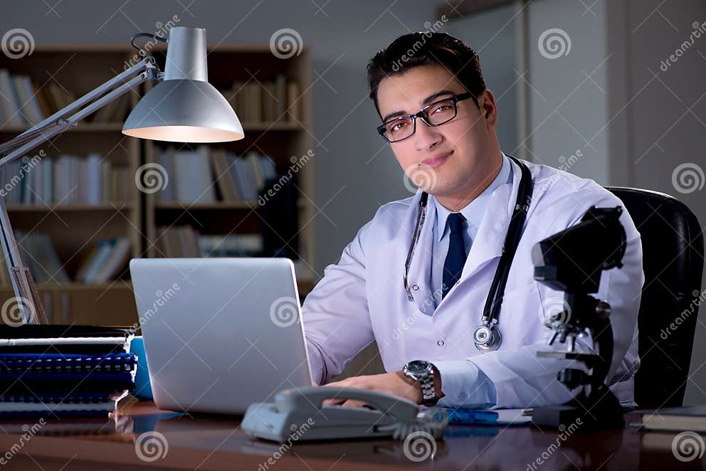 The Young Doctor Working Late in the Office Stock Photo - Image of ...