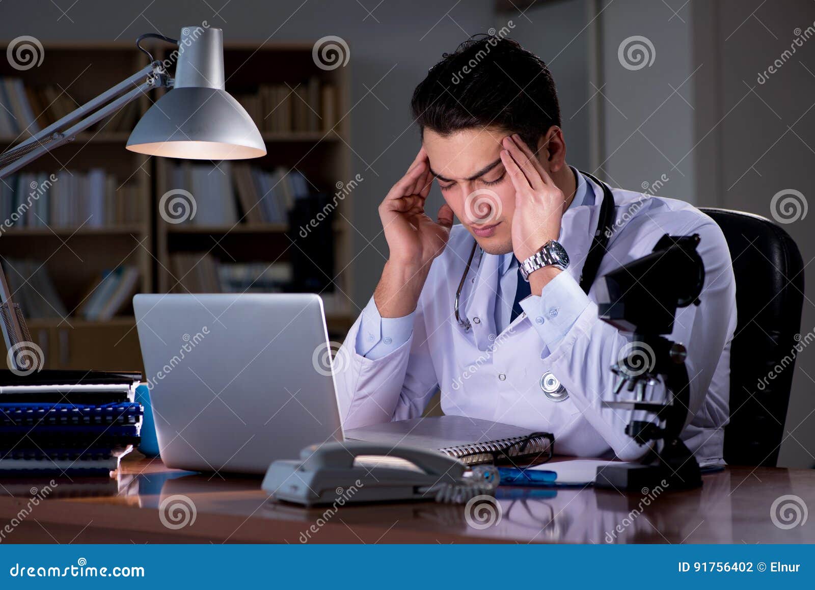 The Young Doctor Working Late in the Office Stock Photo - Image of ...