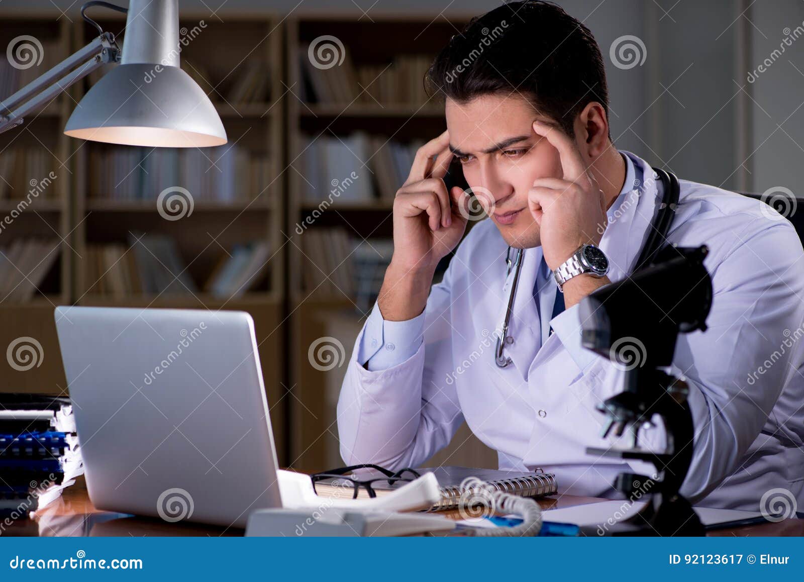 The Young Doctor Working Late in the Office Stock Image - Image of ...