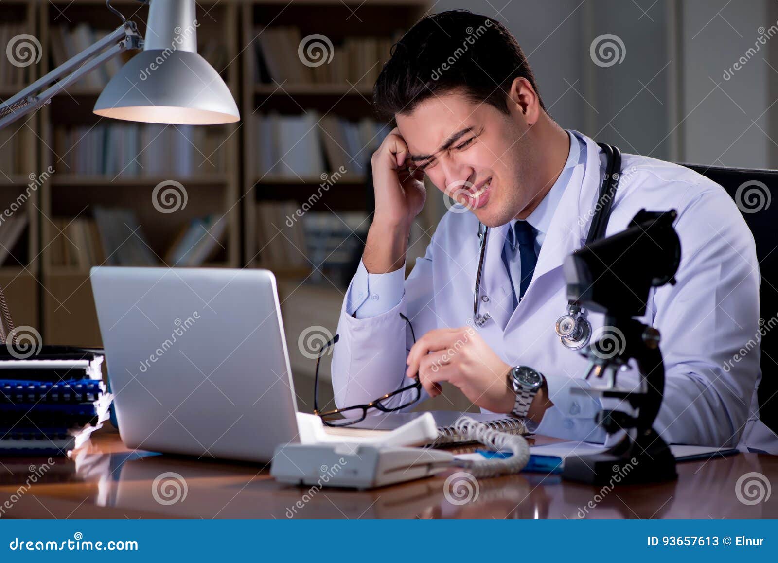 The Young Doctor Working Late in the Office Stock Image - Image of ...