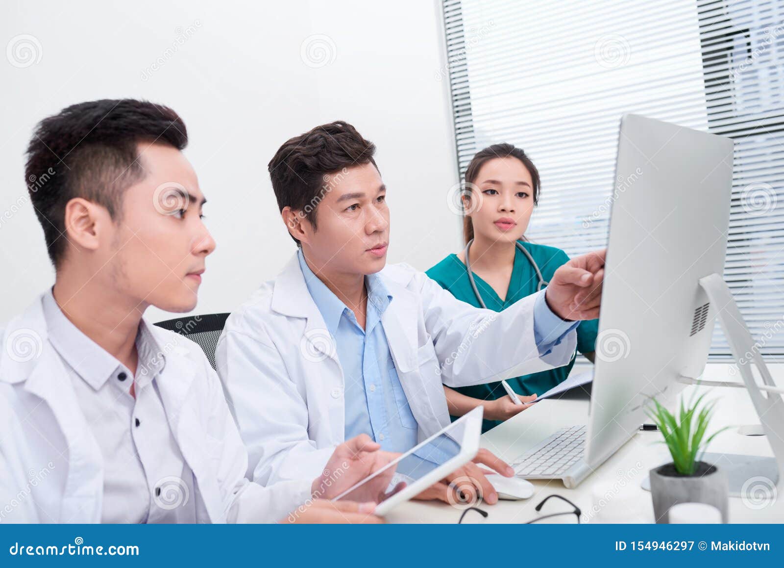 Young Doctors Using Computer in Hospital Office Stock Image - Image of ...