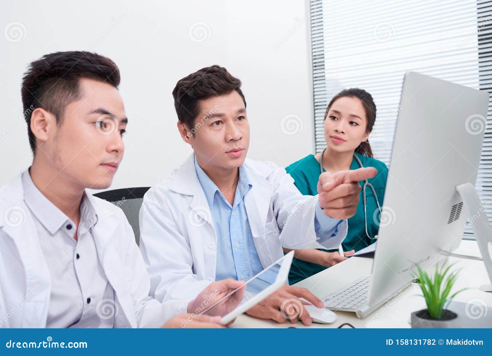 Young Doctors Using Computer in Hospital Office Stock Photo - Image of ...