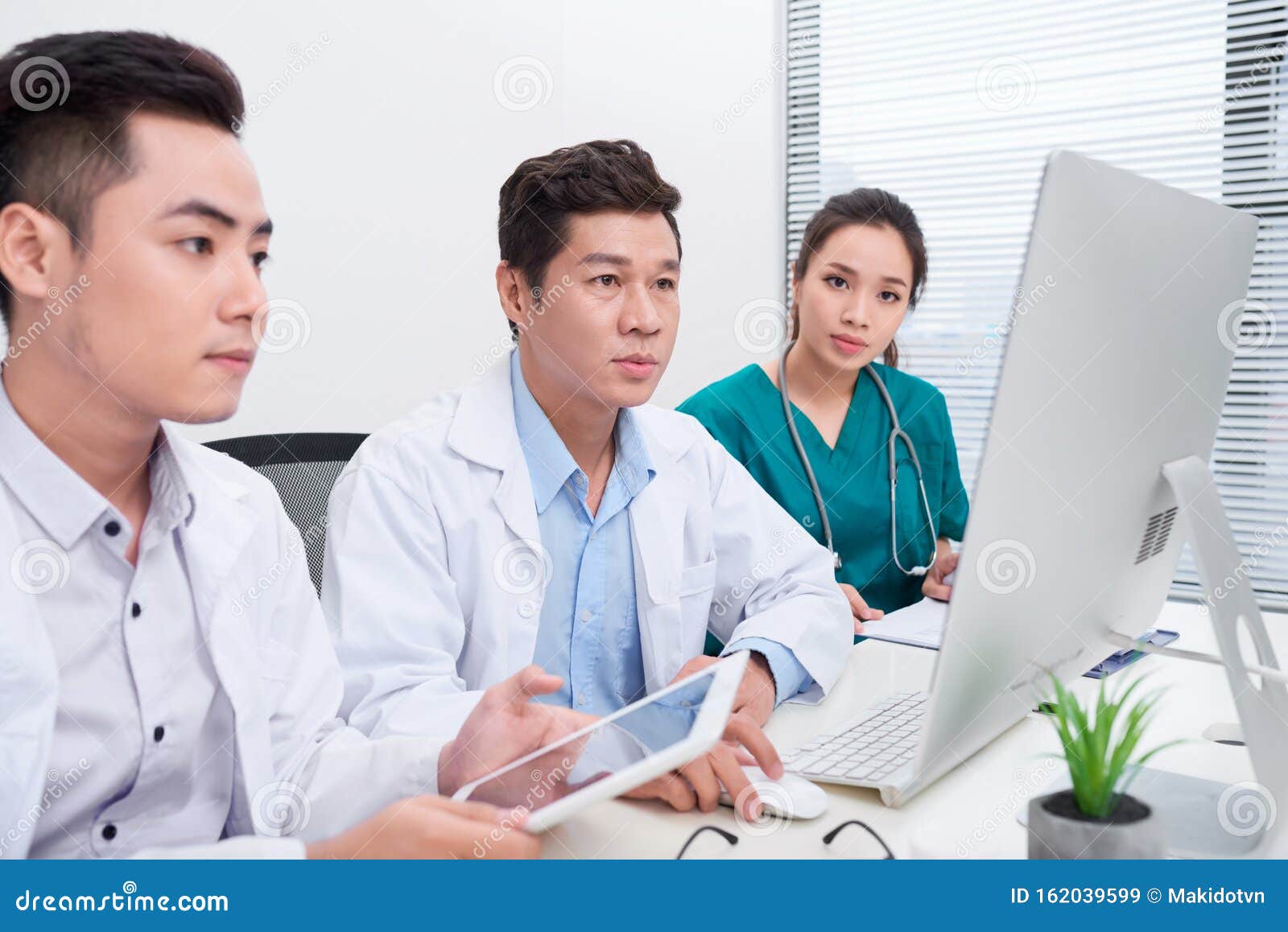 Young Doctors Using Computer in Hospital Office Stock Image - Image of ...