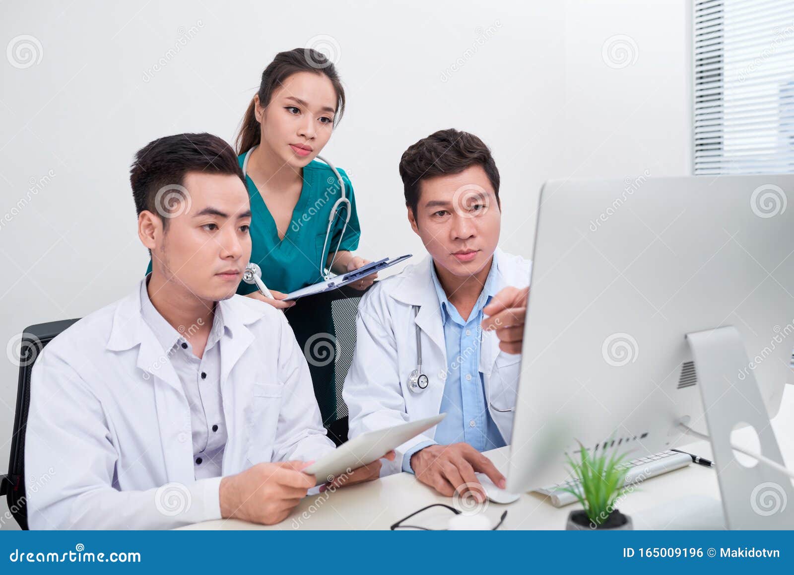 Young Doctors Using Computer in Hospital Office Stock Photo - Image of ...