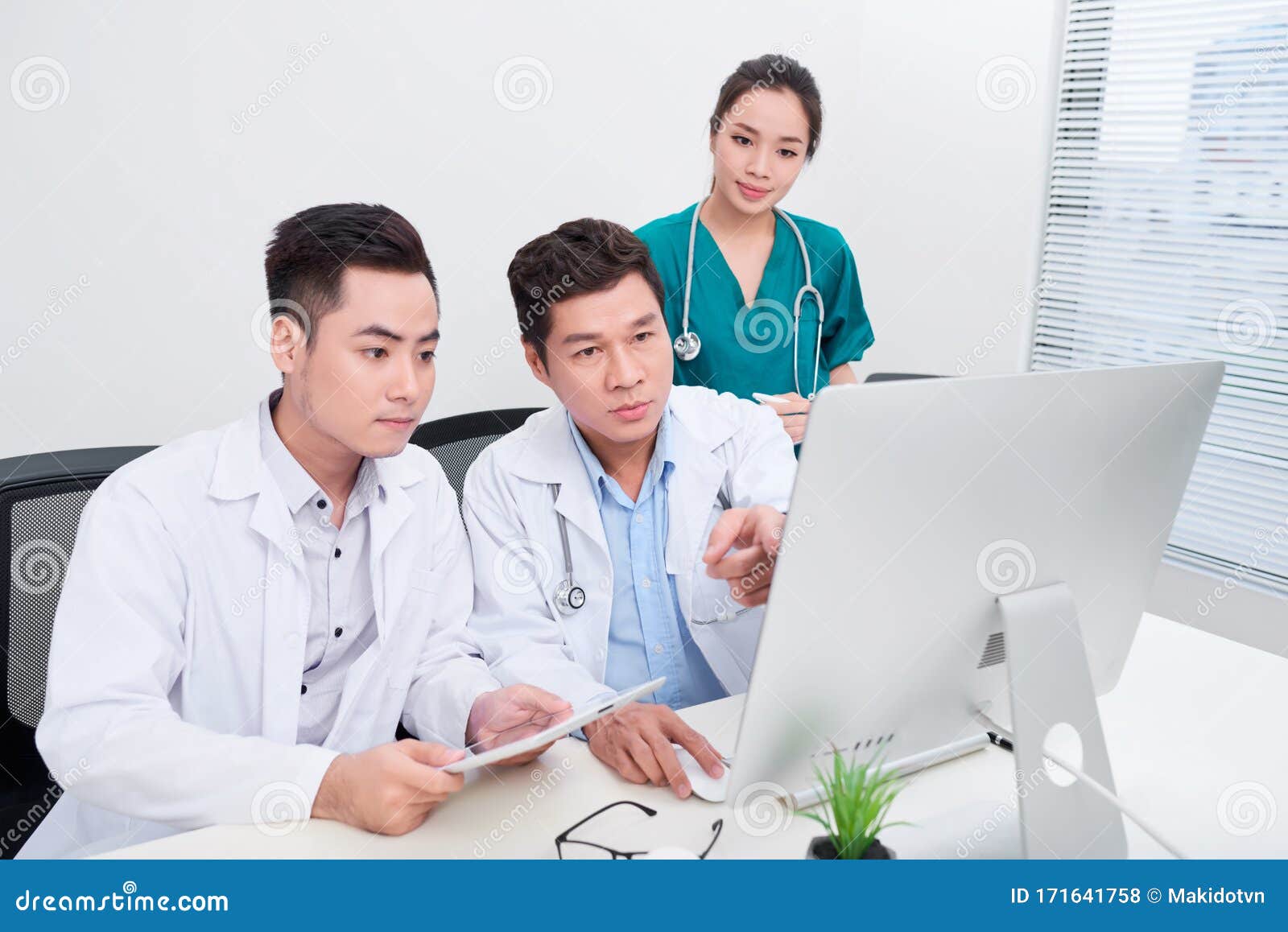 Young Doctors Using Computer in Hospital Office Stock Photo - Image of ...