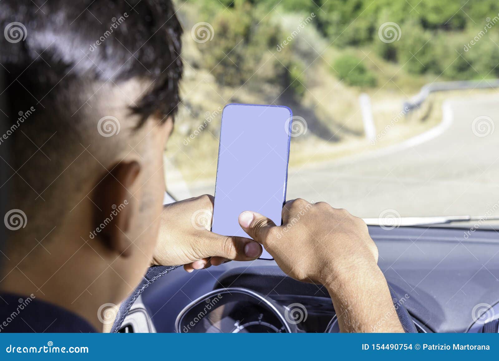 Young Driver, Using Smartphone, on the Road in the Car Stock Photo ...