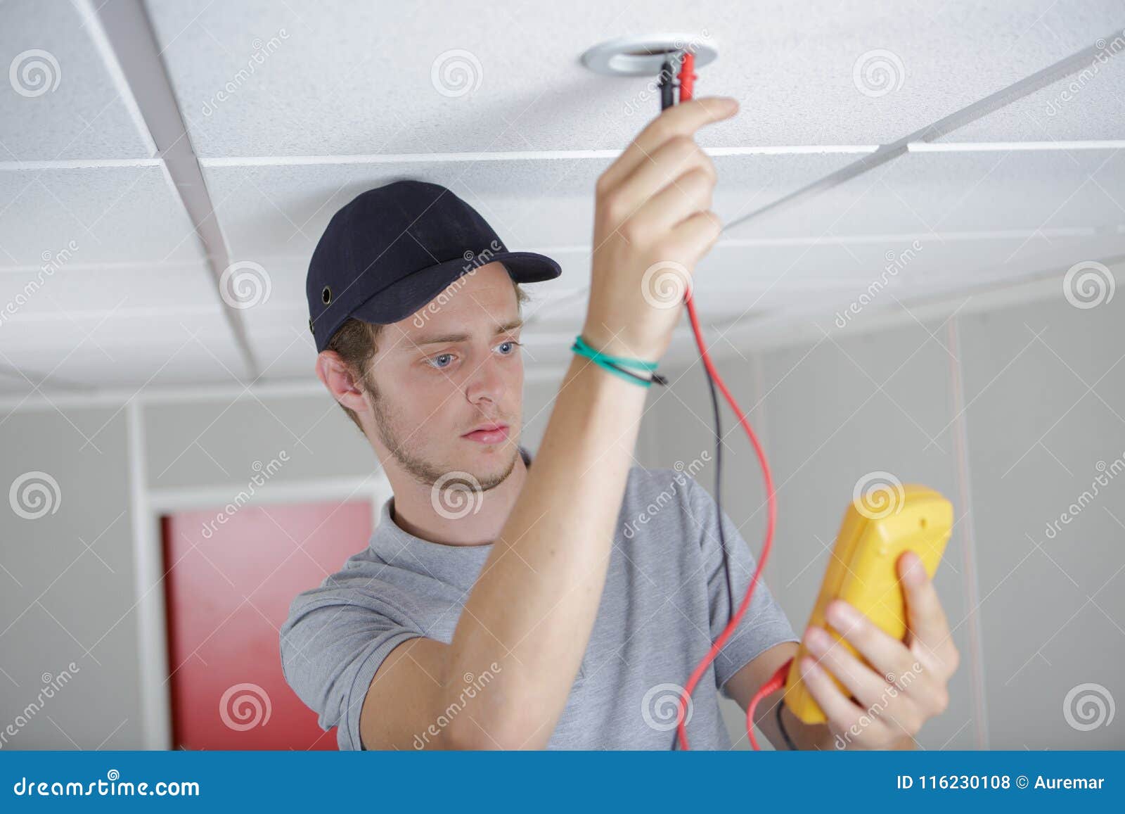 Young Electrician Testing Spotlight Socket Stock Photo - Image of light ...