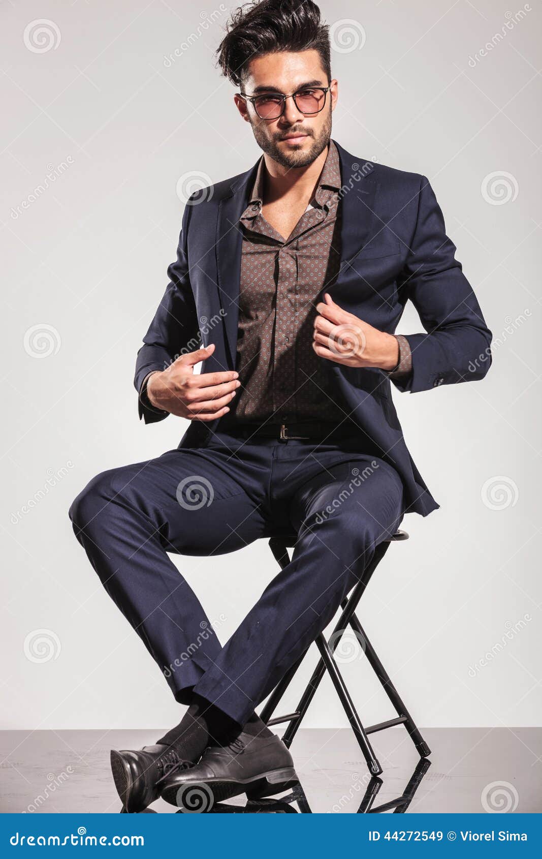 Young Elegant Man Opening His Coat Sitting on Chair Stock Image - Image ...