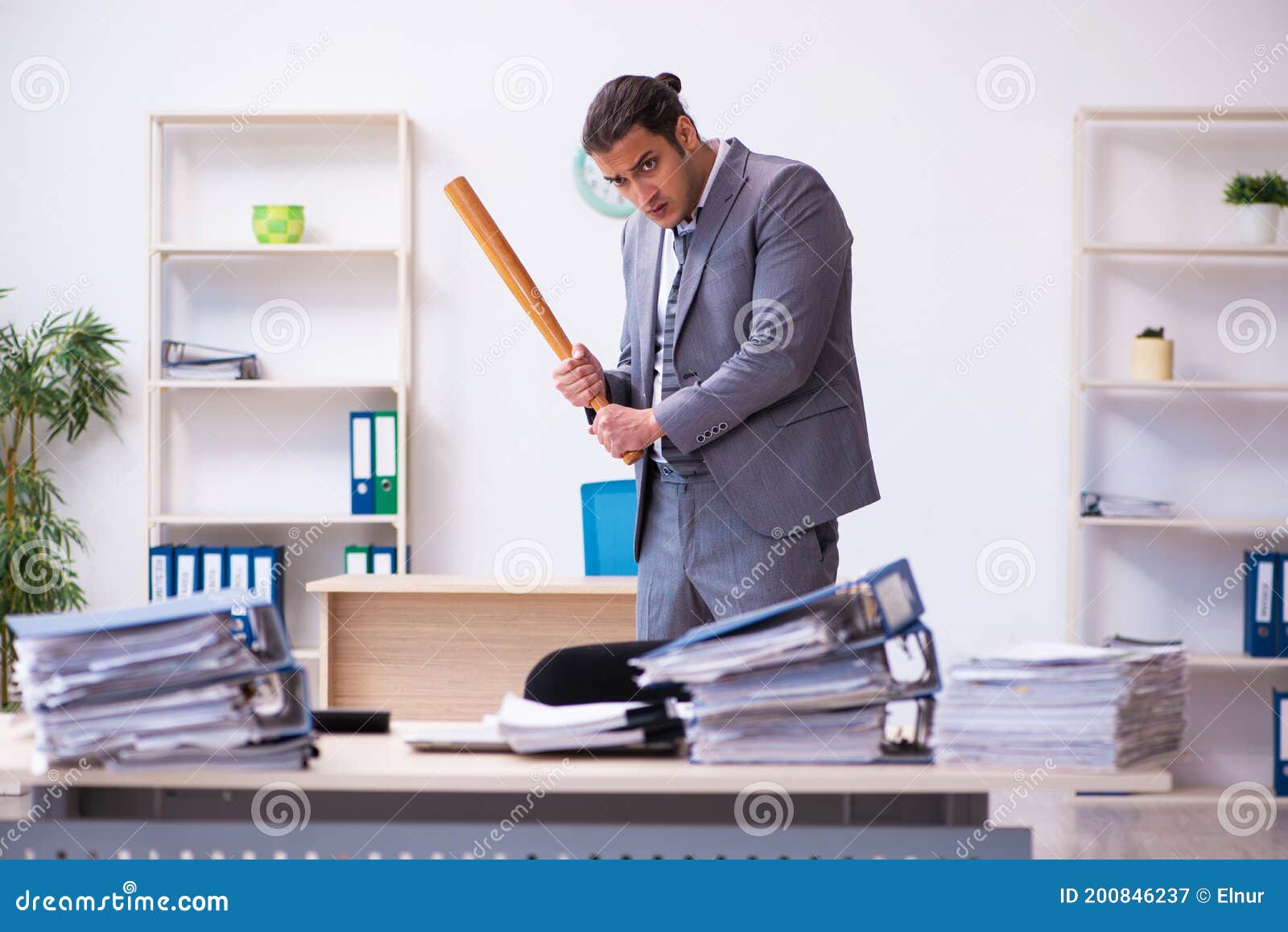 Young Employee Angry with Excessive Work Holding Baseball Bat Stock ...