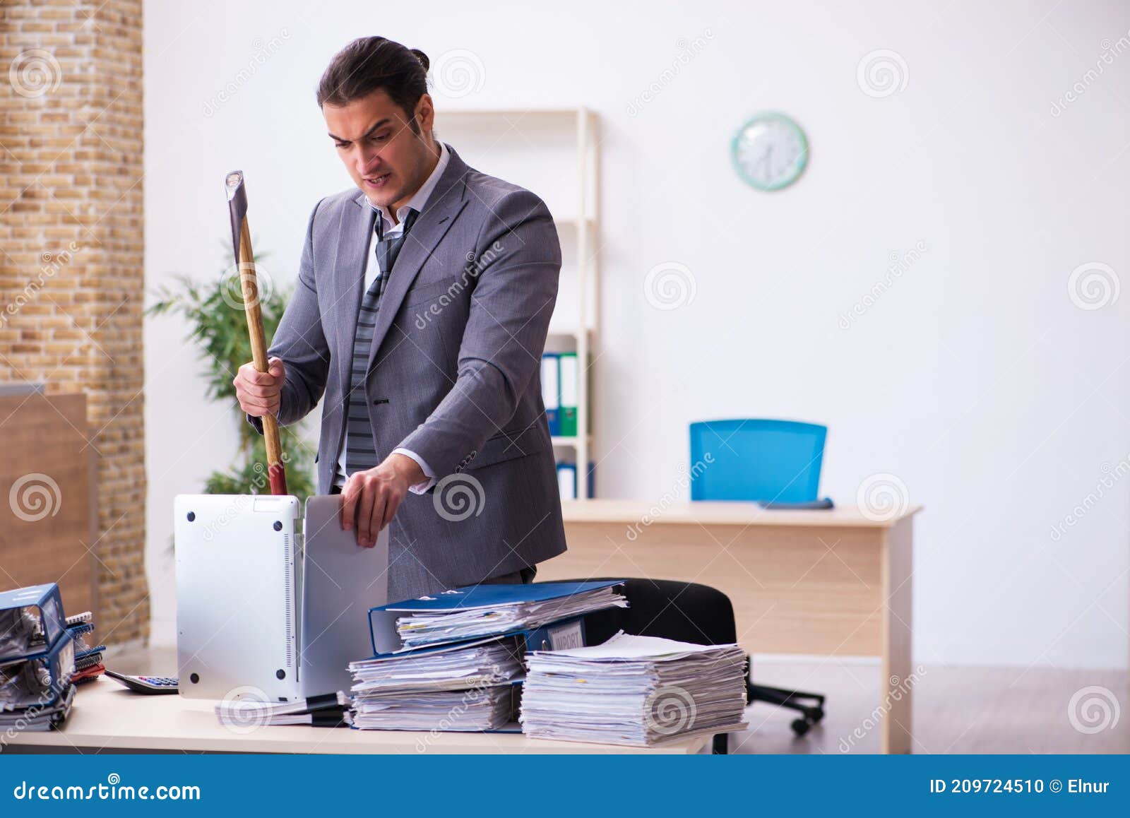 Young Employee Angry with Excessive Work Holding Hatchet Stock Photo ...