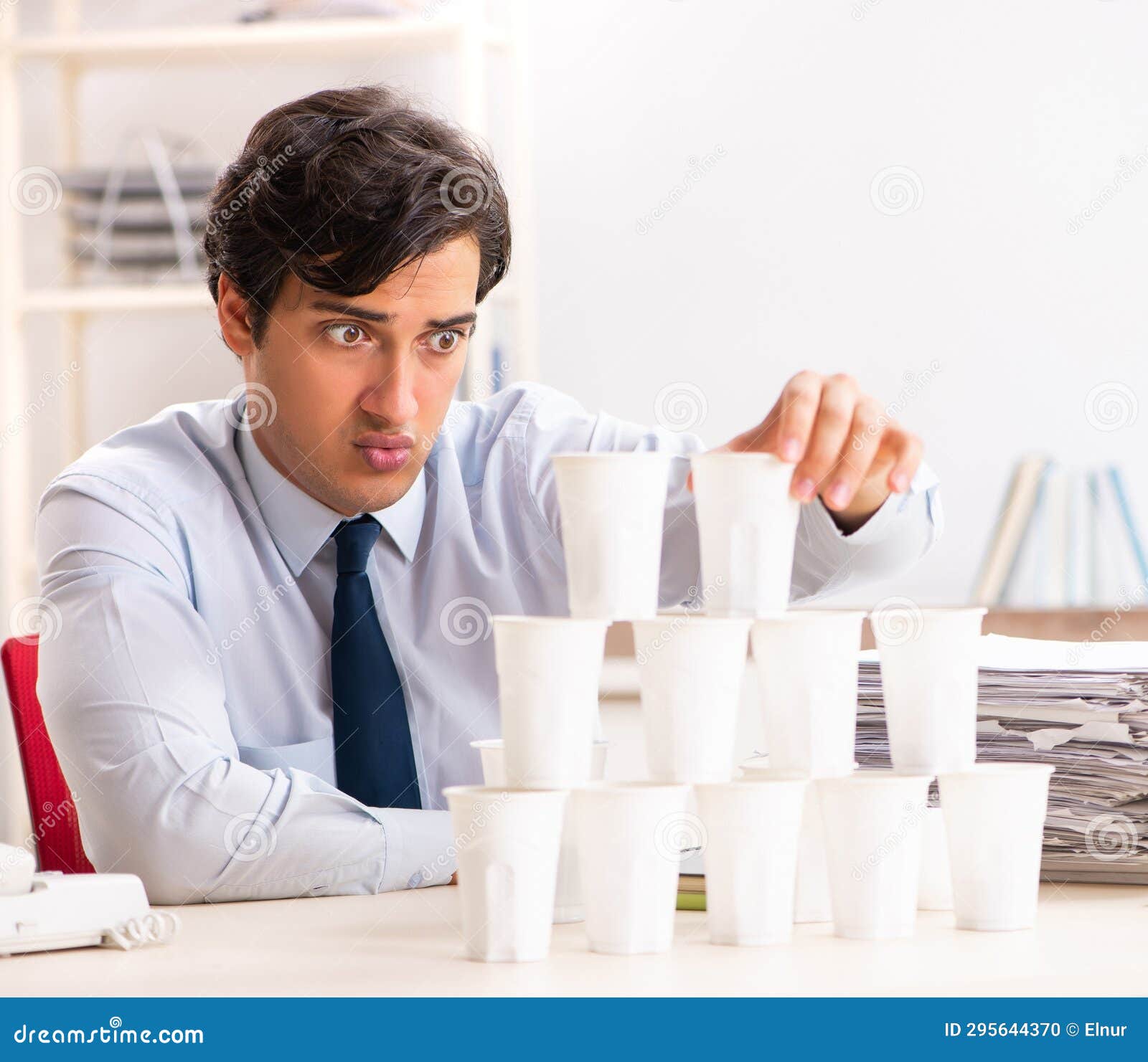 Young Employee Building Pyramid from Plastic Cups Stock Photo - Image ...