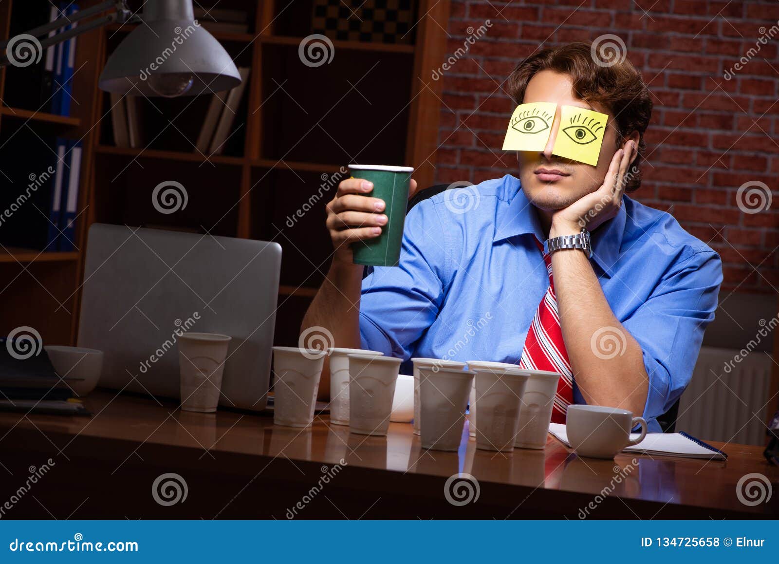 The Young Employee Drinking Coffee Working at Night Shift Stock Photo ...