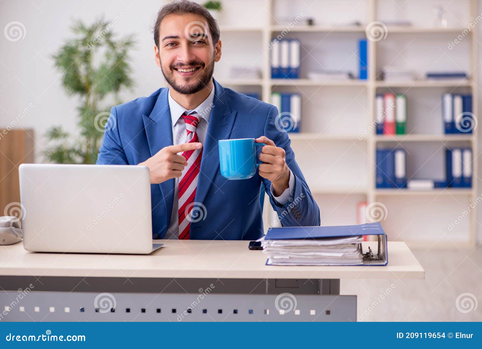 Young Male Employee Drinking Coffee at Workplace Stock Photo - Image of ...
