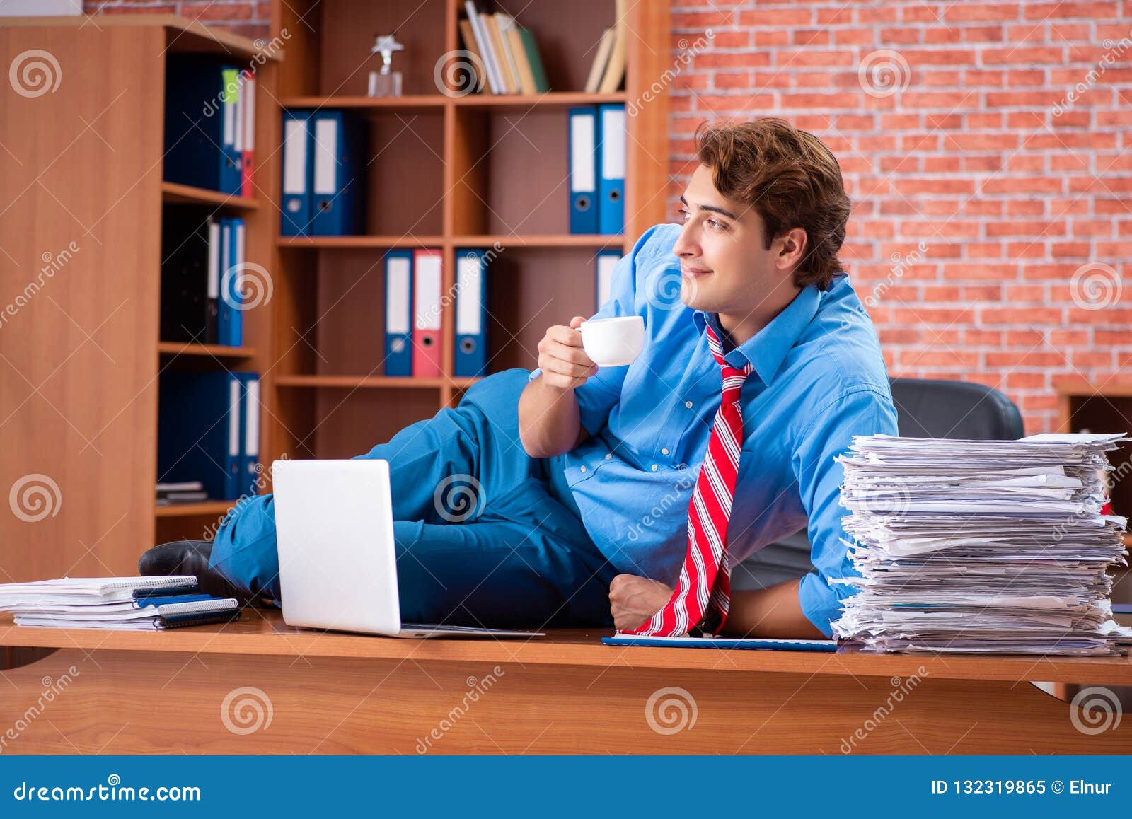The Young Employee with Excessive Work Sitting at the Office Stock ...