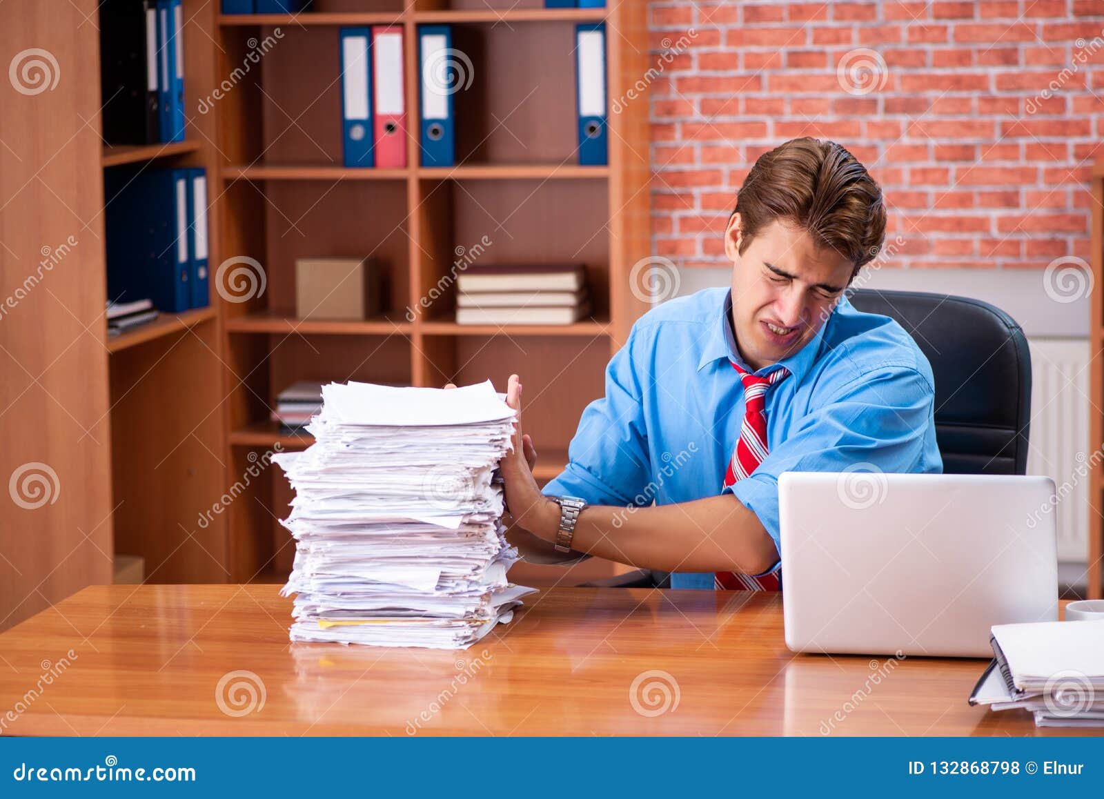 The Young Employee with Excessive Work Sitting at the Office Stock ...