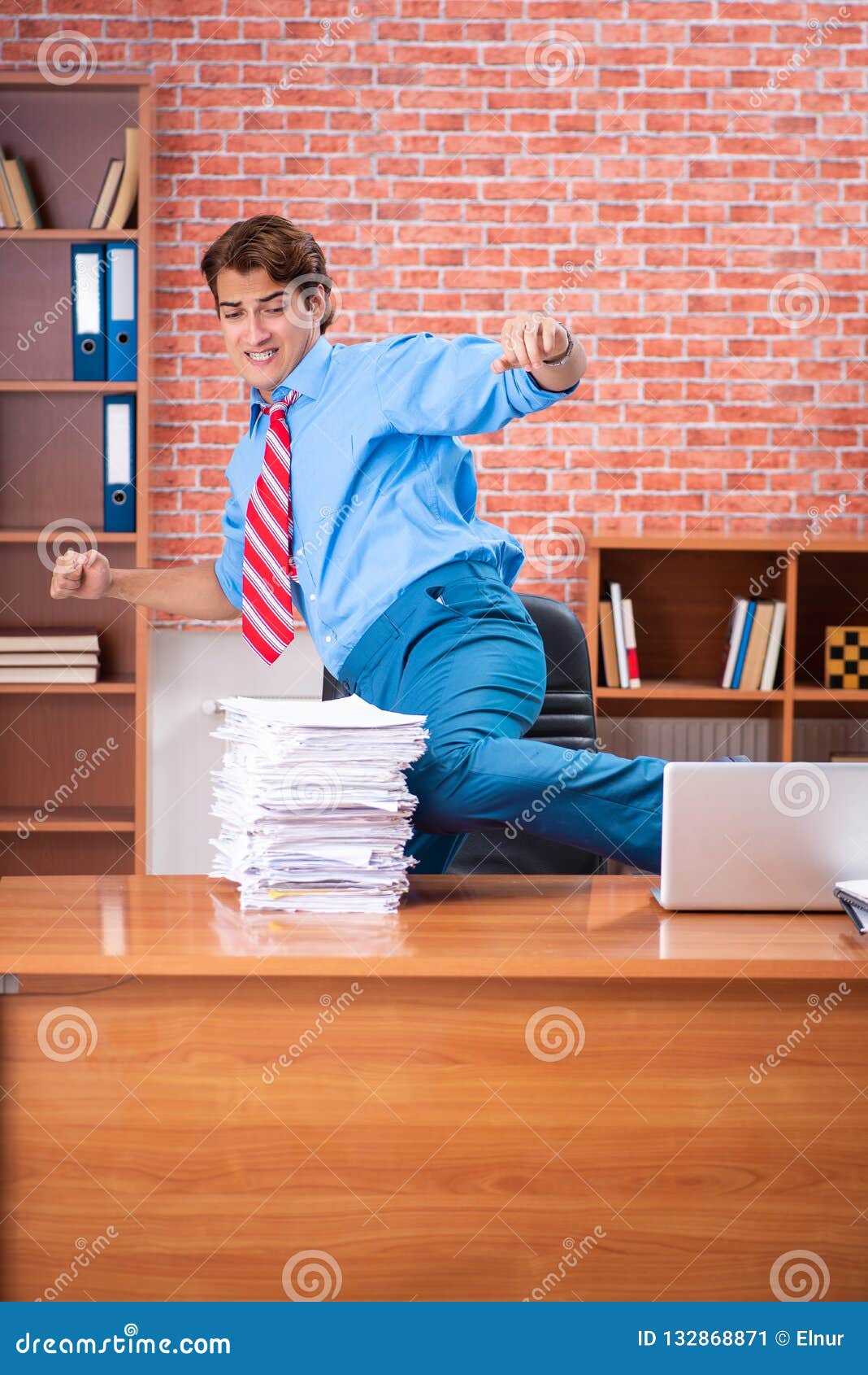 The Young Employee with Excessive Work Sitting at the Office Stock ...