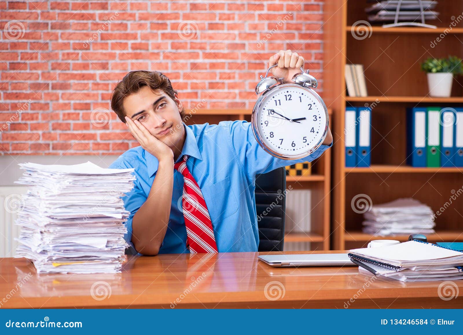 The Young Employee with Excessive Work Sitting at the Office Stock ...