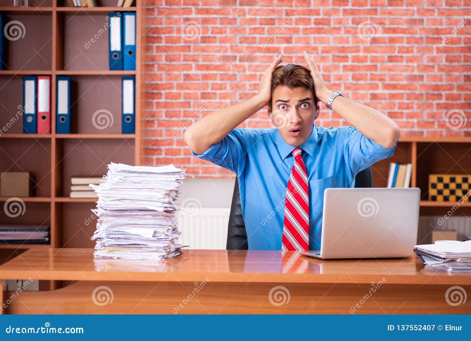 The Young Employee with Excessive Work Sitting at the Office Stock ...