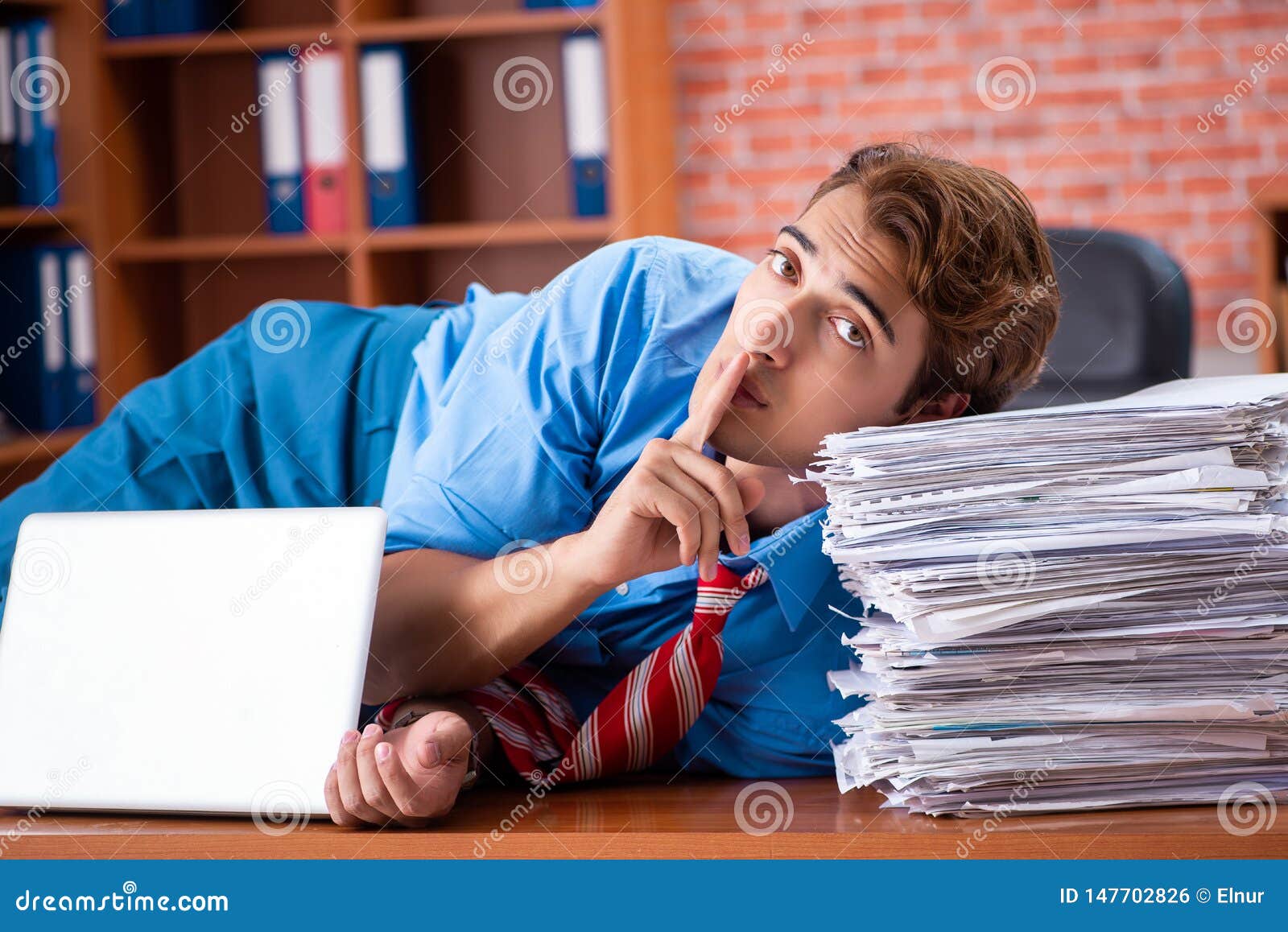 The Young Employee with Excessive Work Sitting at the Office Stock ...