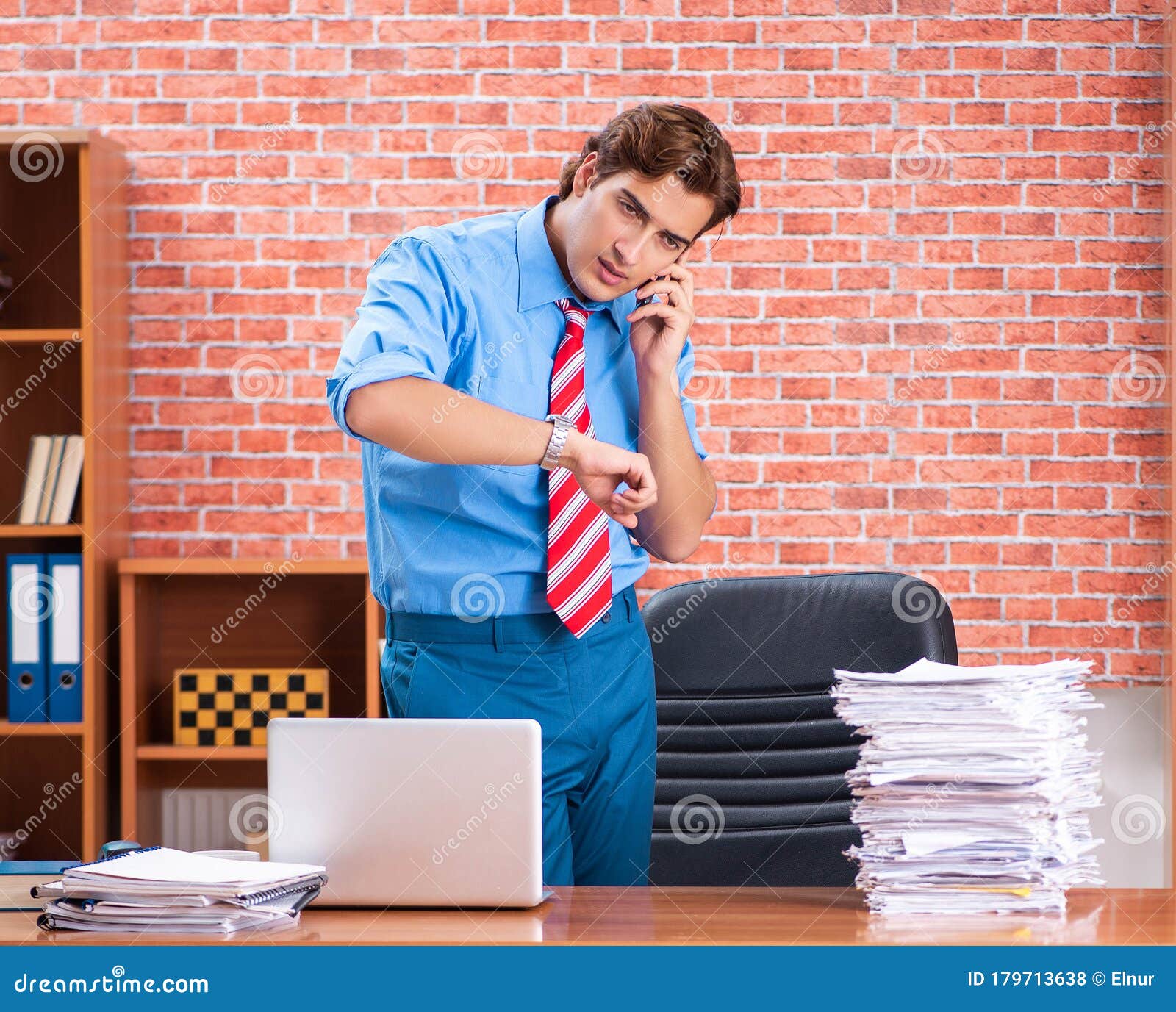 Young Employee with Excessive Work Sitting at the Office Stock Photo ...