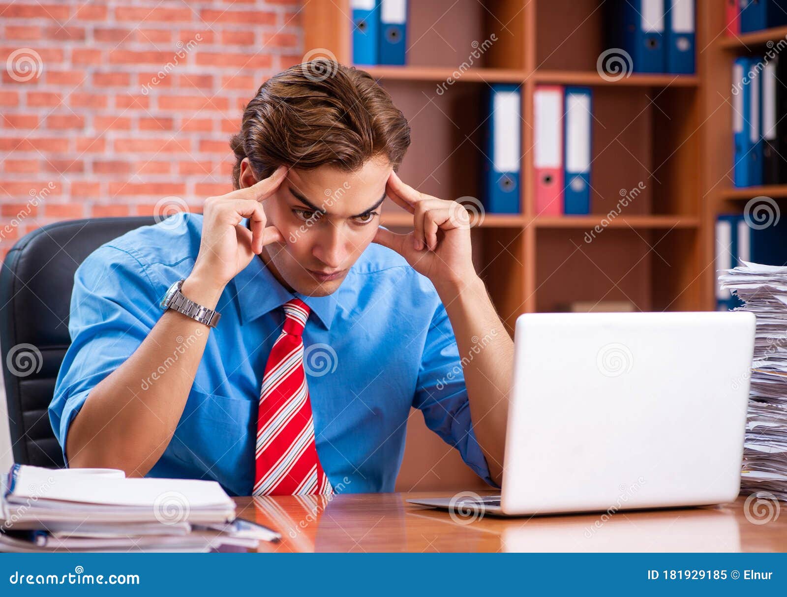 Young Employee with Excessive Work Sitting at the Office Stock Image ...