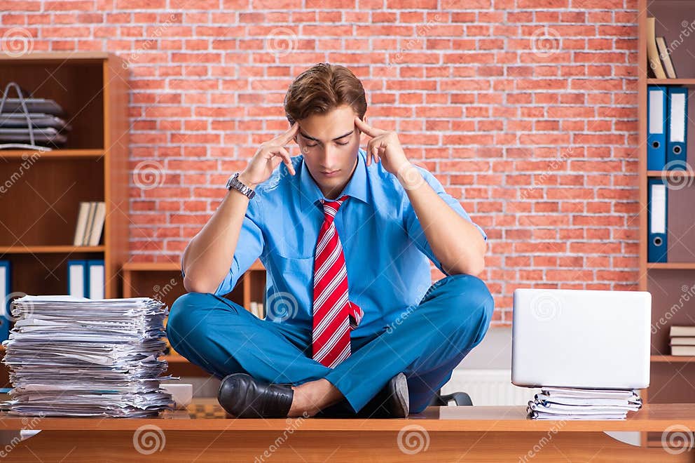 Young Employee with Excessive Work Sitting at the Office Stock Photo ...