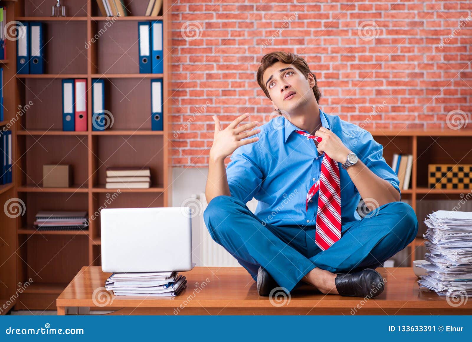 The Young Employee with Excessive Work Sitting at the Office Stock ...