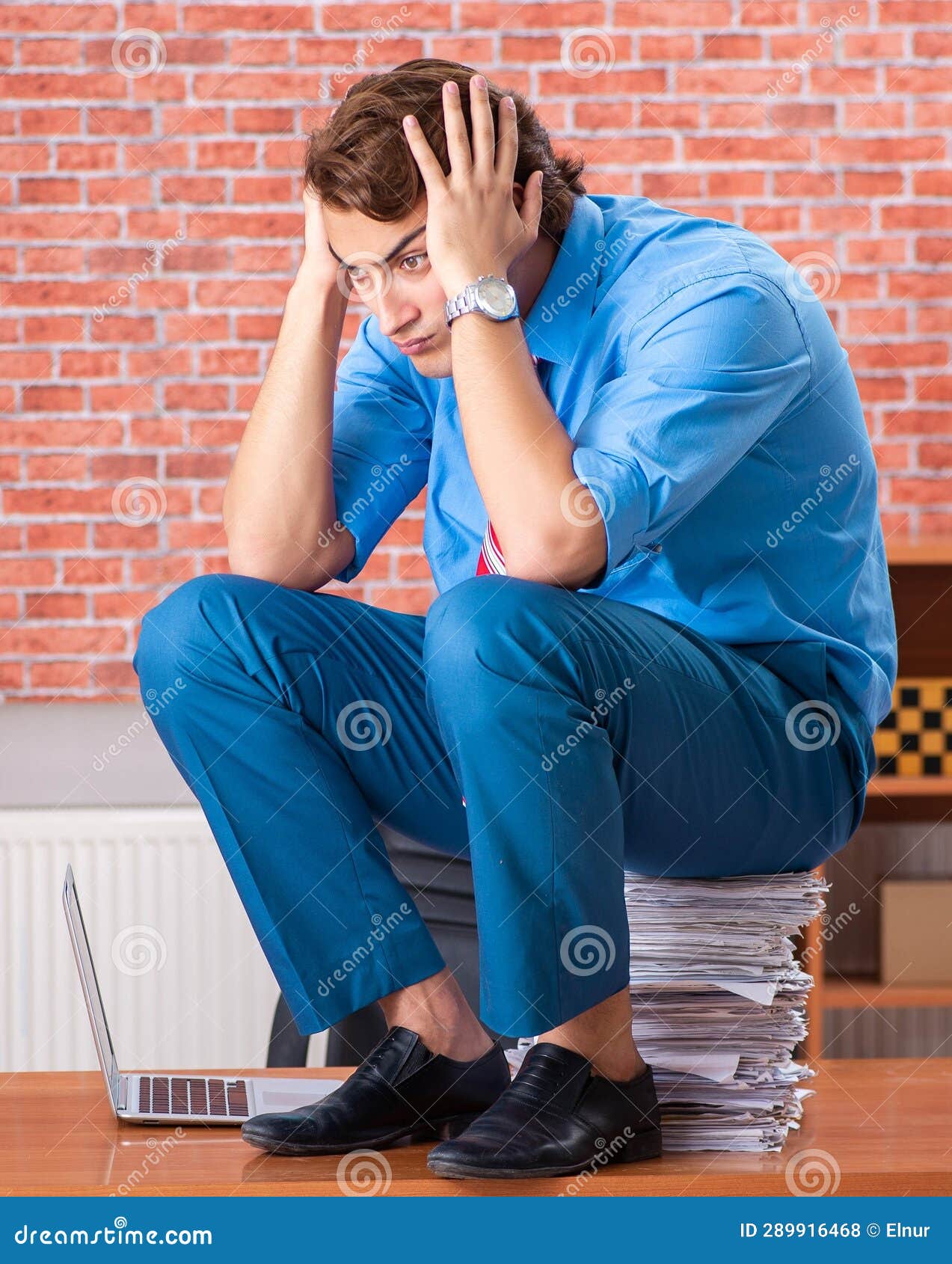 Young Employee with Excessive Work Sitting at the Office Stock Photo ...