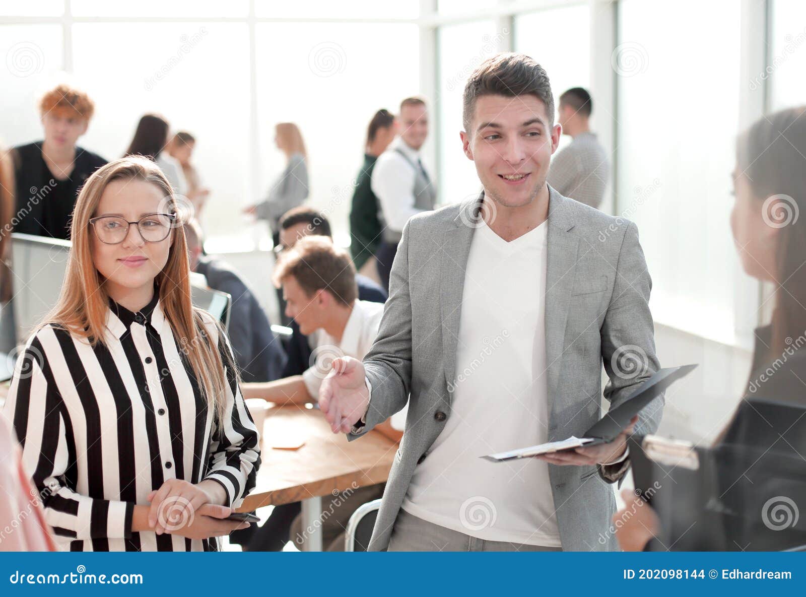 Young Employee Explaining Something To His Colleagues. Stock Photo ...