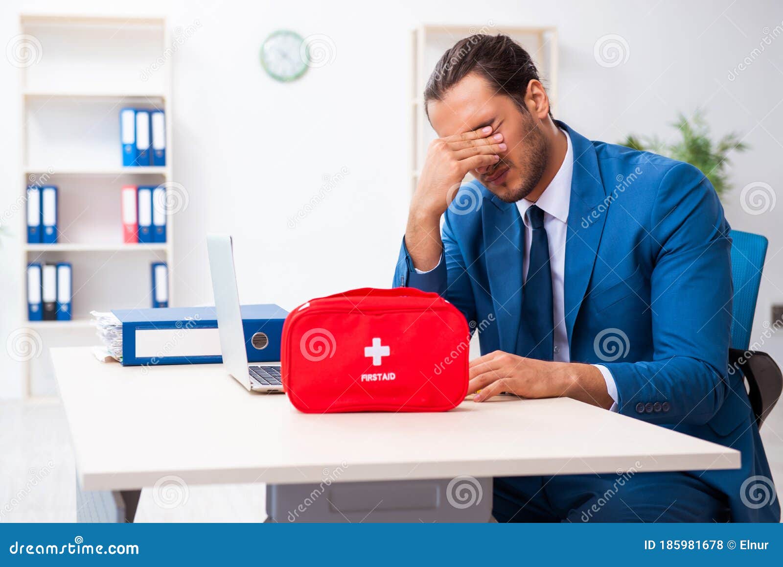 Young Male Employee in First Aid Concept Stock Photo - Image of ...