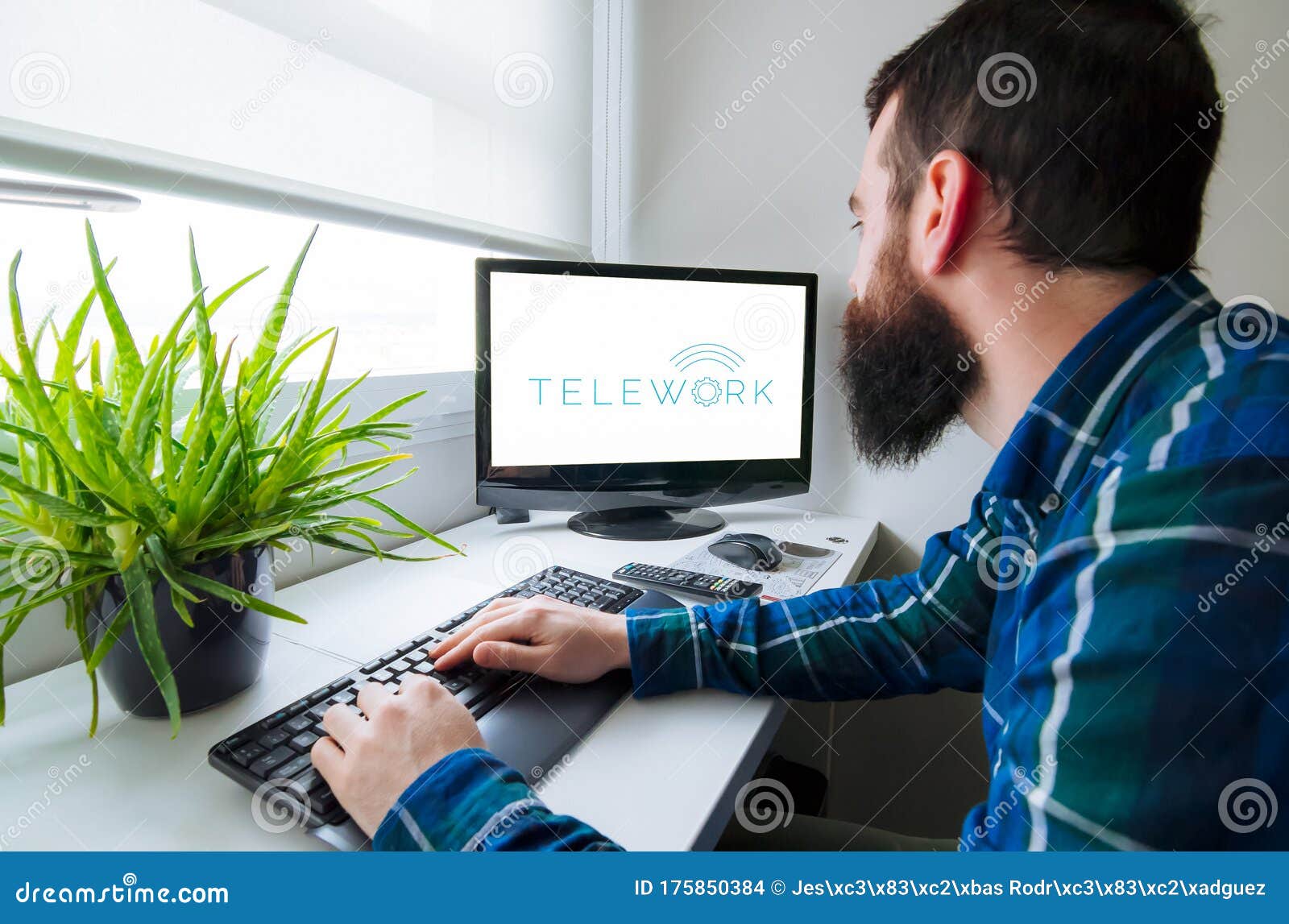 Working from Home. Man in Front of Computer with Telework Logo on the ...