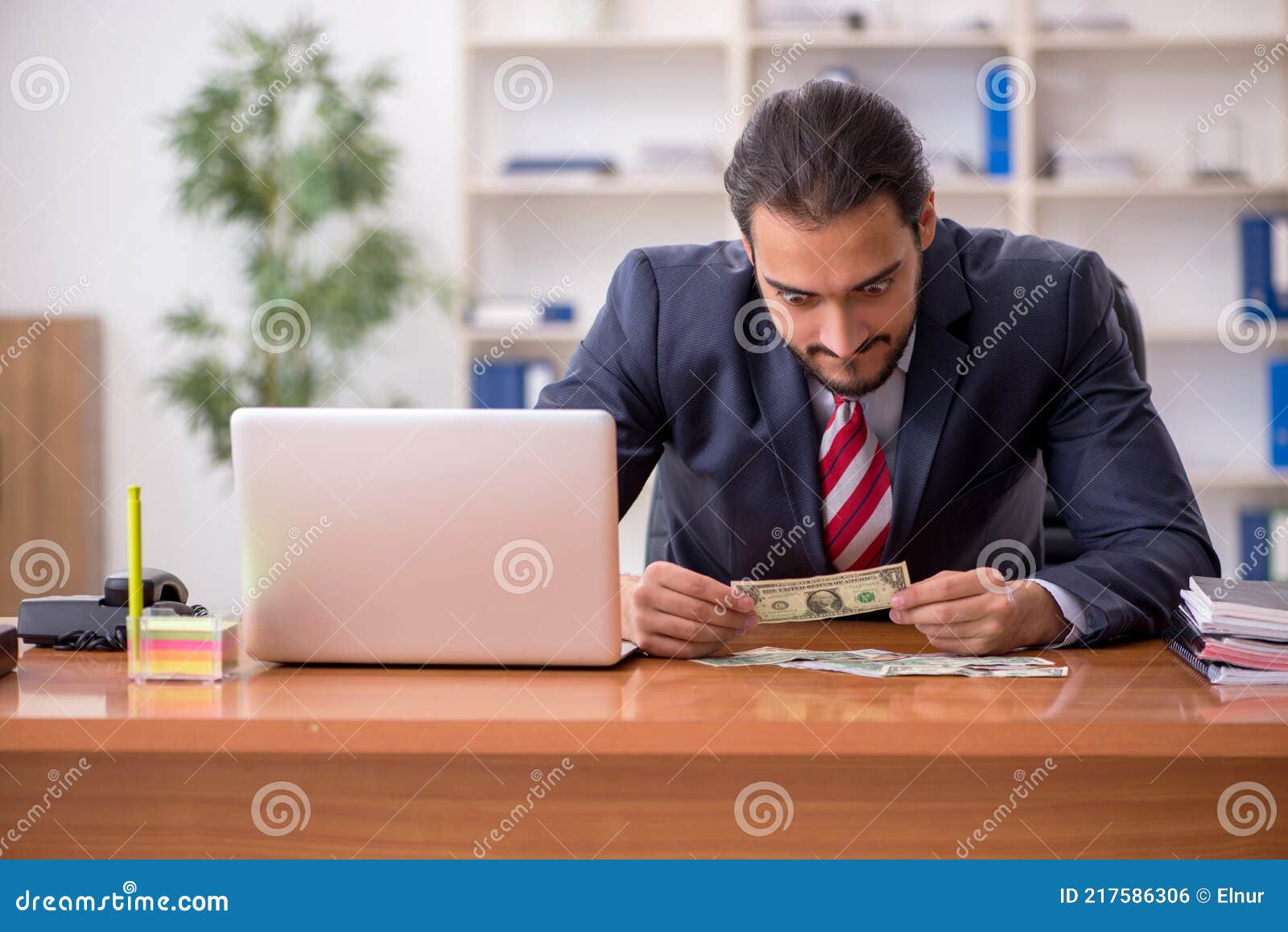 Young Male Employee Holding Banknotes in the Office Stock Photo - Image ...