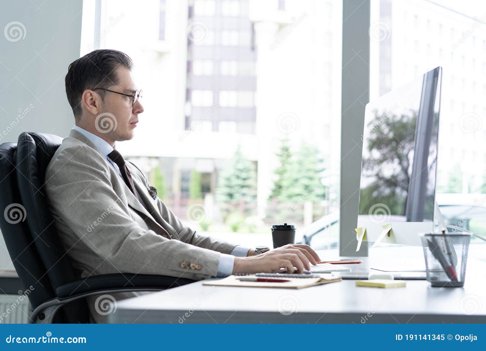 Young Employee Looking at Computer Monitor during Working Day in Office ...