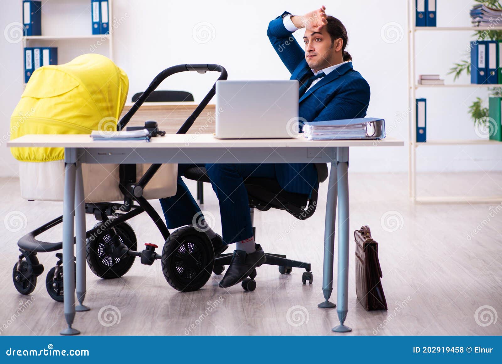 Young Male Employee Looking after Kid at Workplace Stock Photo - Image ...