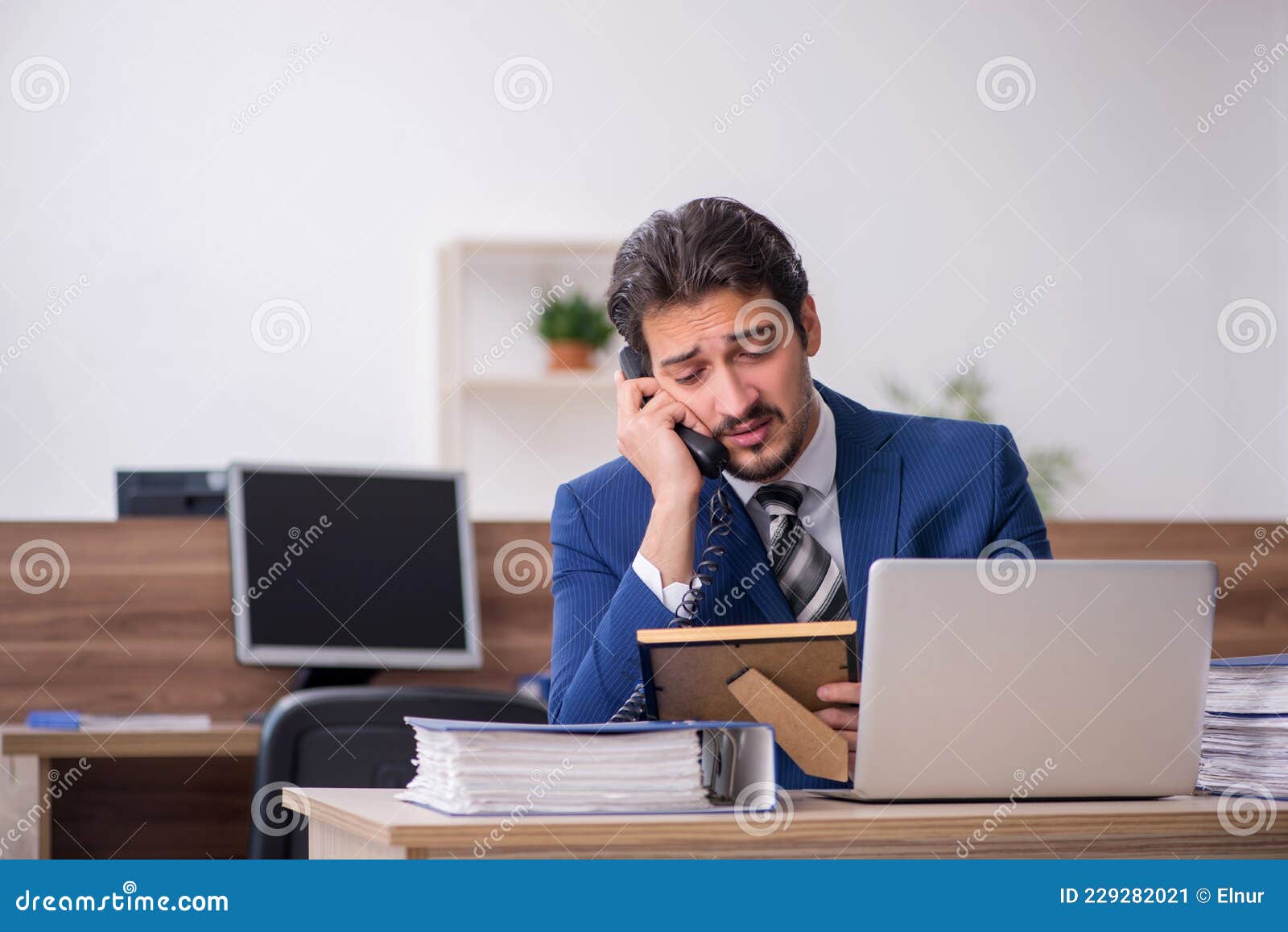 Young Male Employee Missing Girlfriend at Workplace Stock Image - Image ...