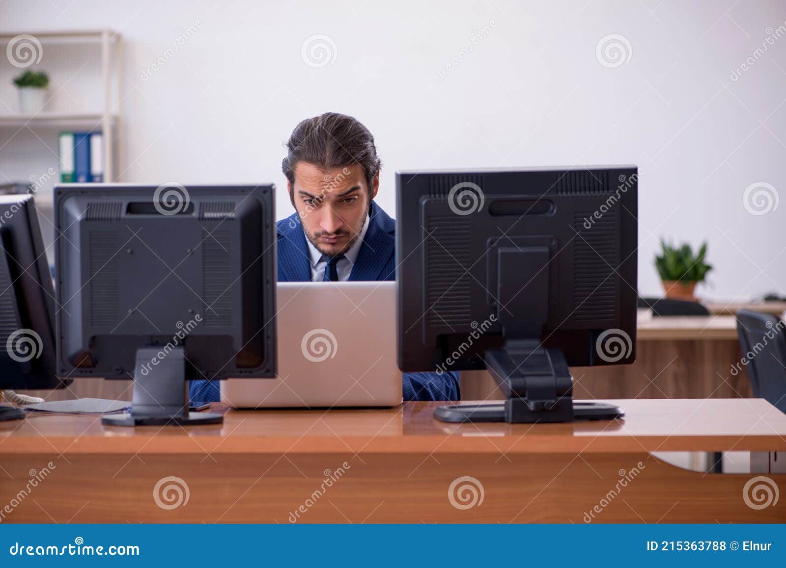 Young Male Employee in Multitasking Concept Stock Photo - Image of ...