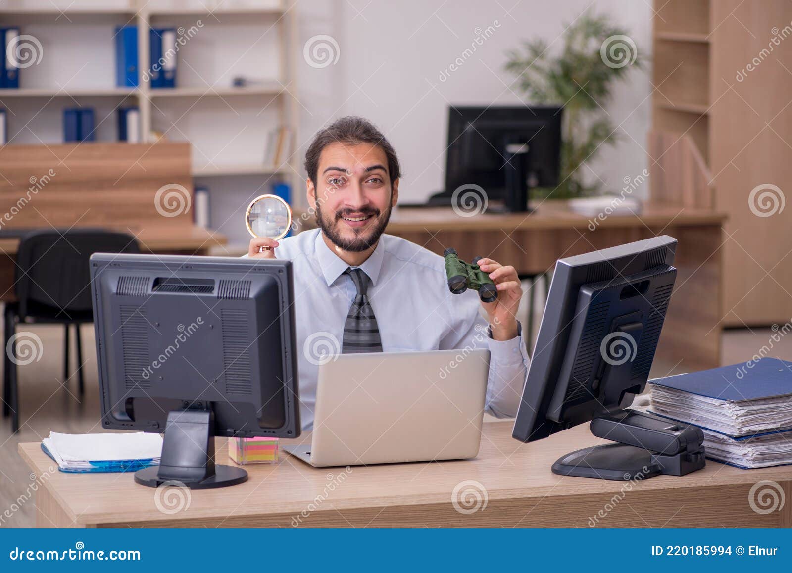 Young Male Employee in Multitasking Concept Stock Photo - Image of ...